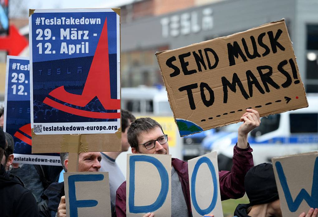 Protesters Swarm Tesla Showrooms to Oppose Elon Musk's Purge of US ...